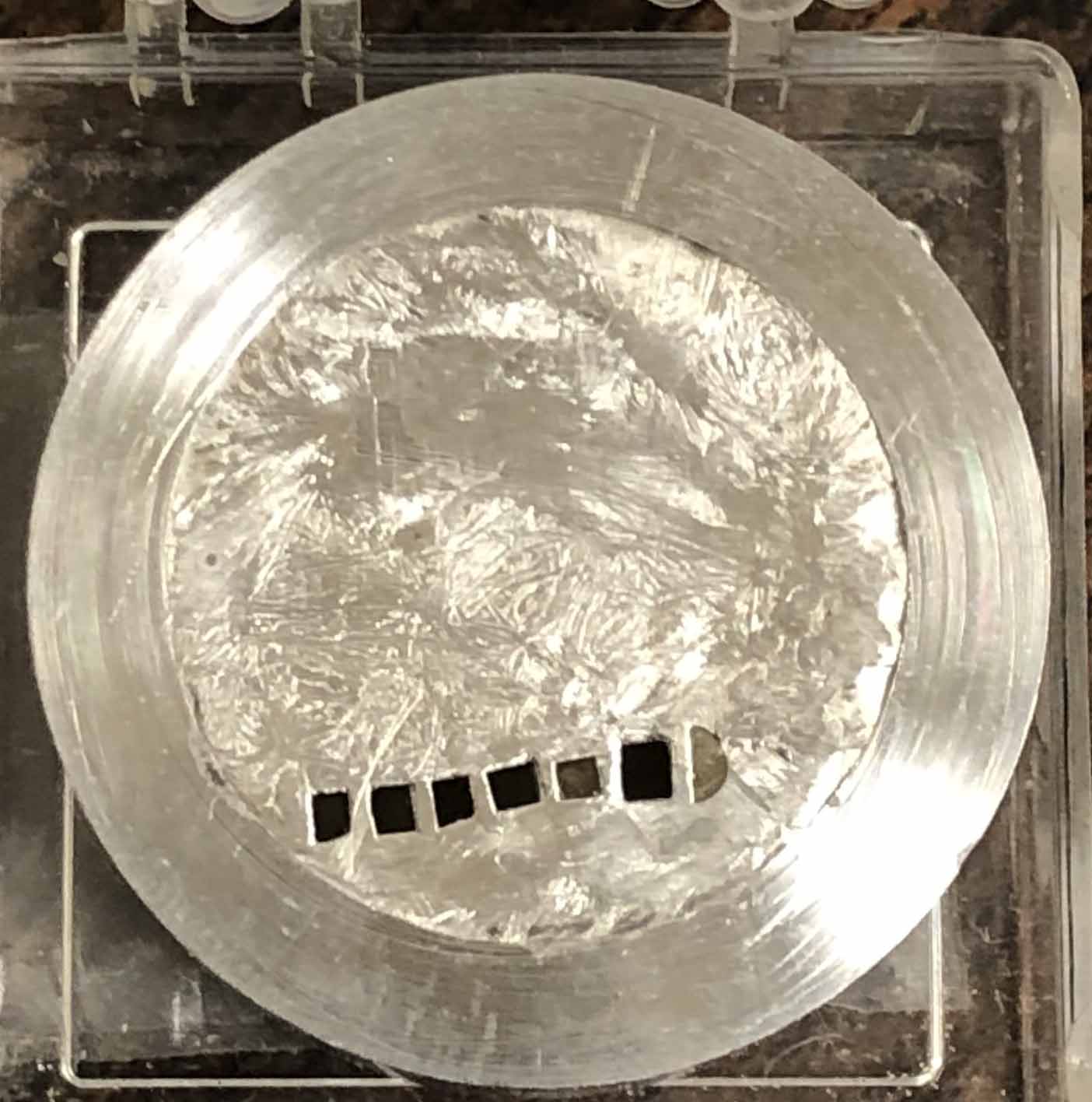 Polished glass chips in indium